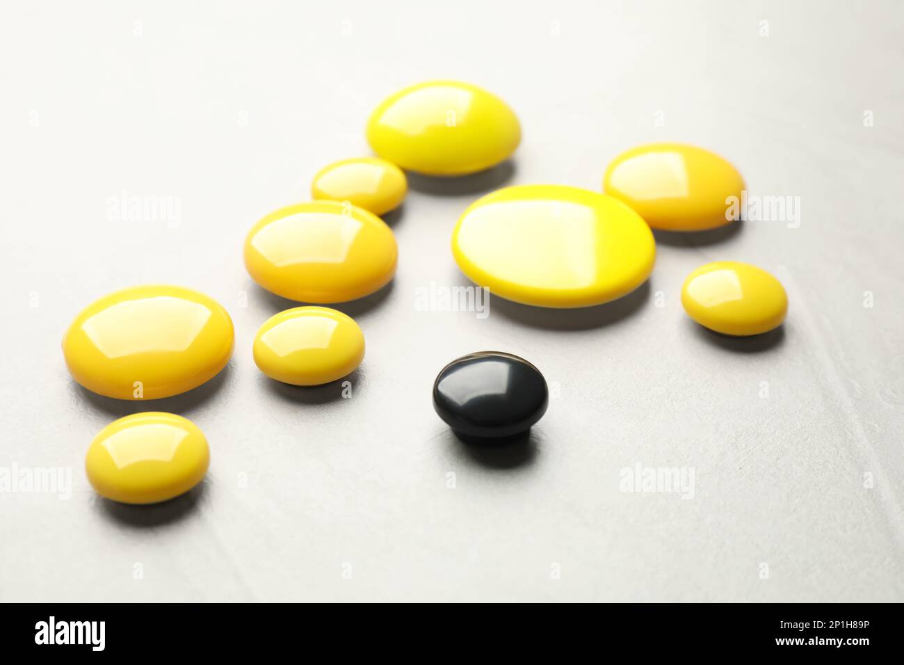 Black and yellow magnets on light grey background. Racism concept Stock ...