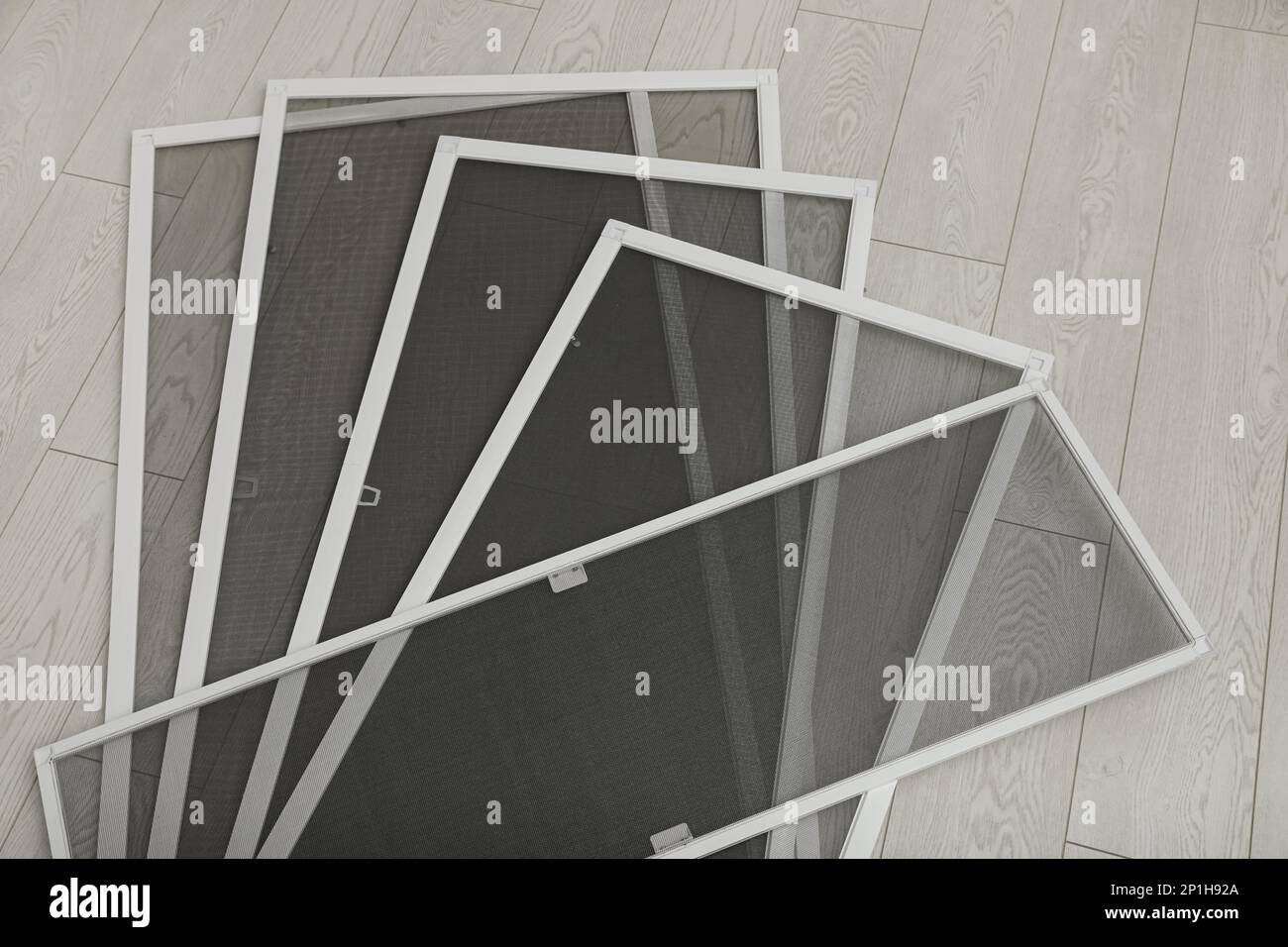 Set of window screens on wooden floor, flat lay Stock Photo - Alamy