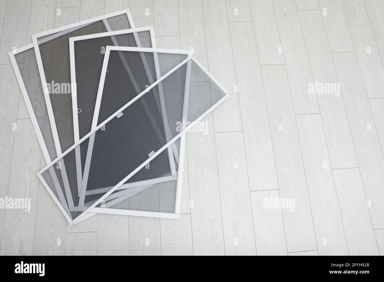 Set of window screens on wooden floor, flat lay. Space for text Stock ...
