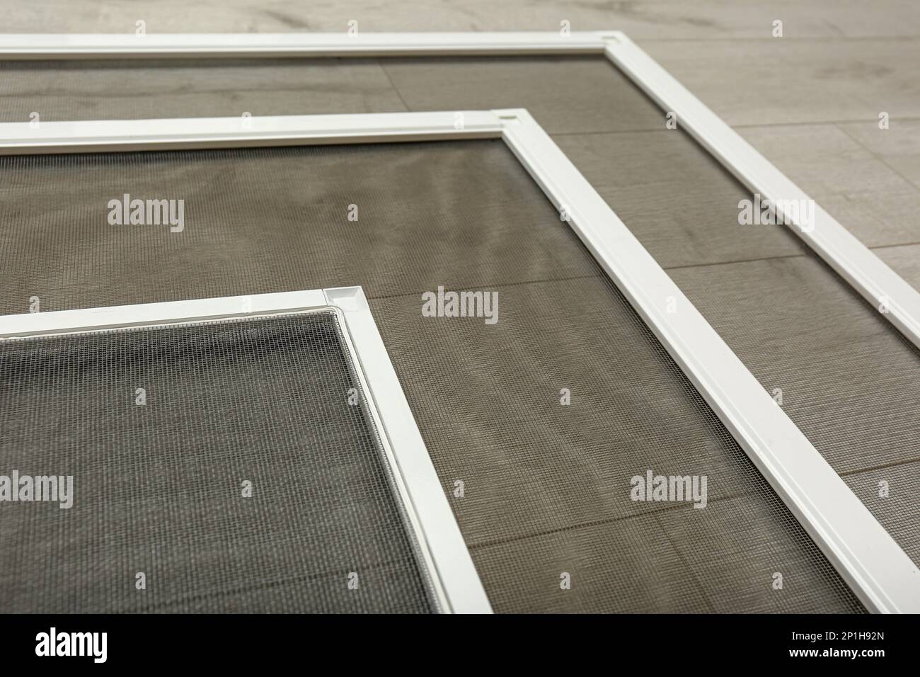 Set of window screens on wooden floor, closeup Stock Photo - Alamy