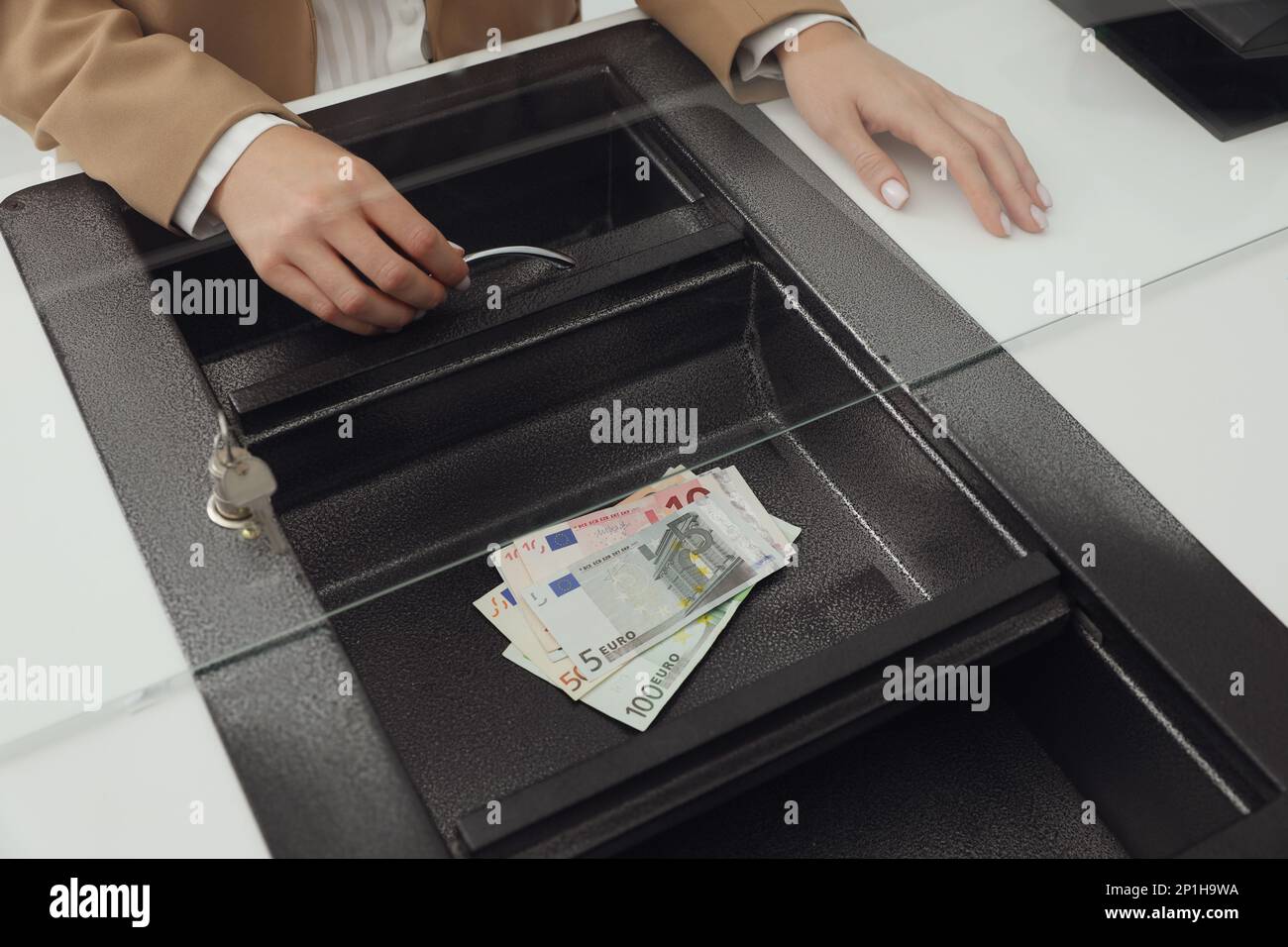 Cashier with money at bank, closeup. Currency exchange Stock Photo - Alamy