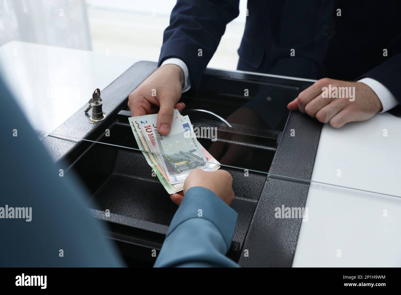Woman giving money to cashier in bank, closeup. Currency exchange Stock Photo - Alamy