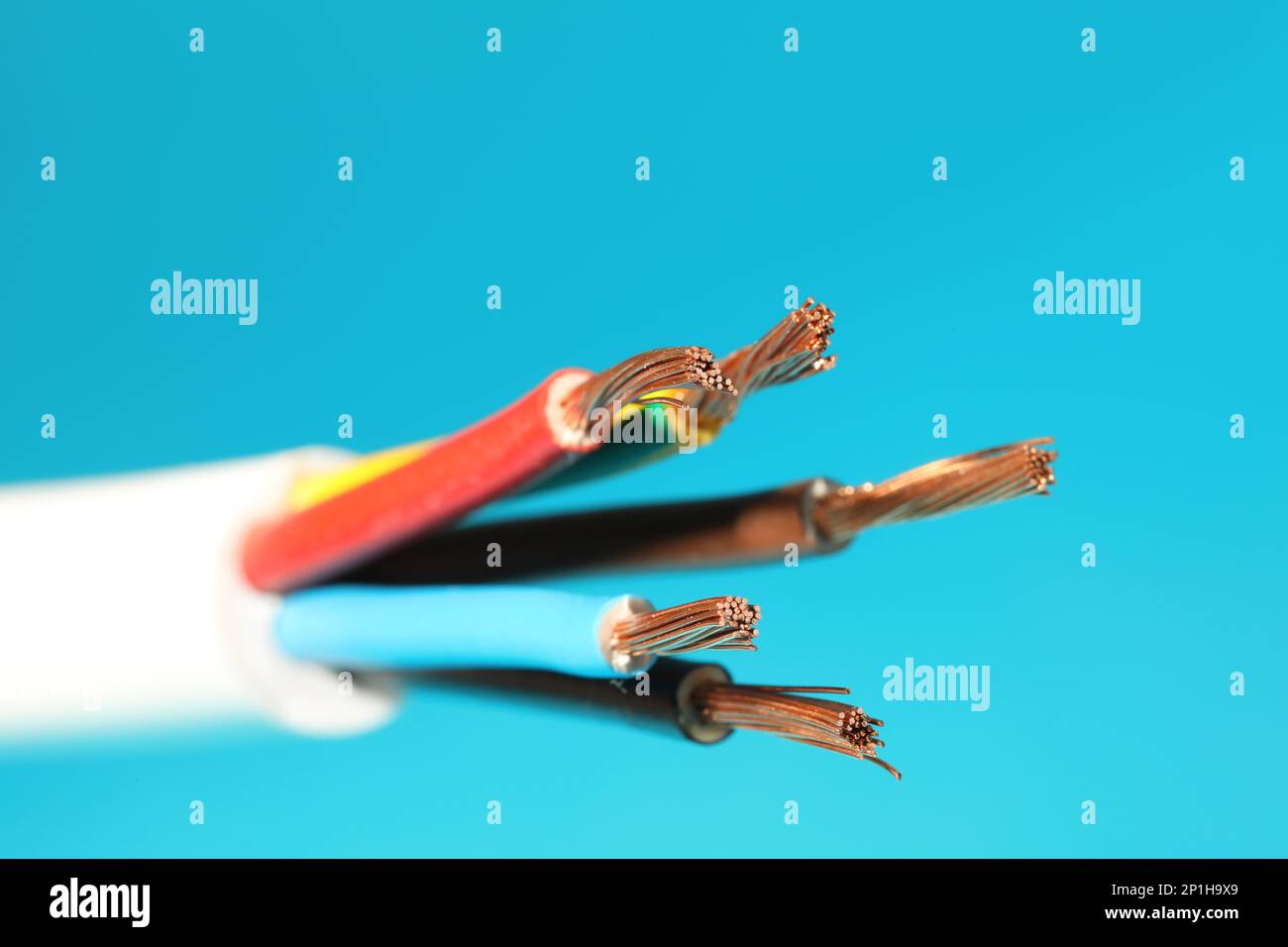 Electrical wires on light blue background, closeup Stock Photo - Alamy