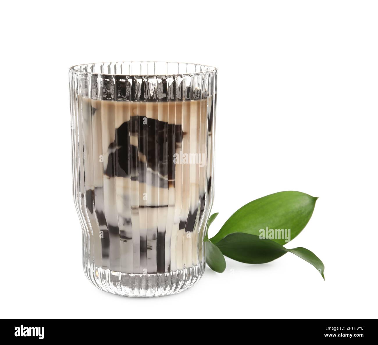 Glass of milk with grass jelly and green leaves on white background ...
