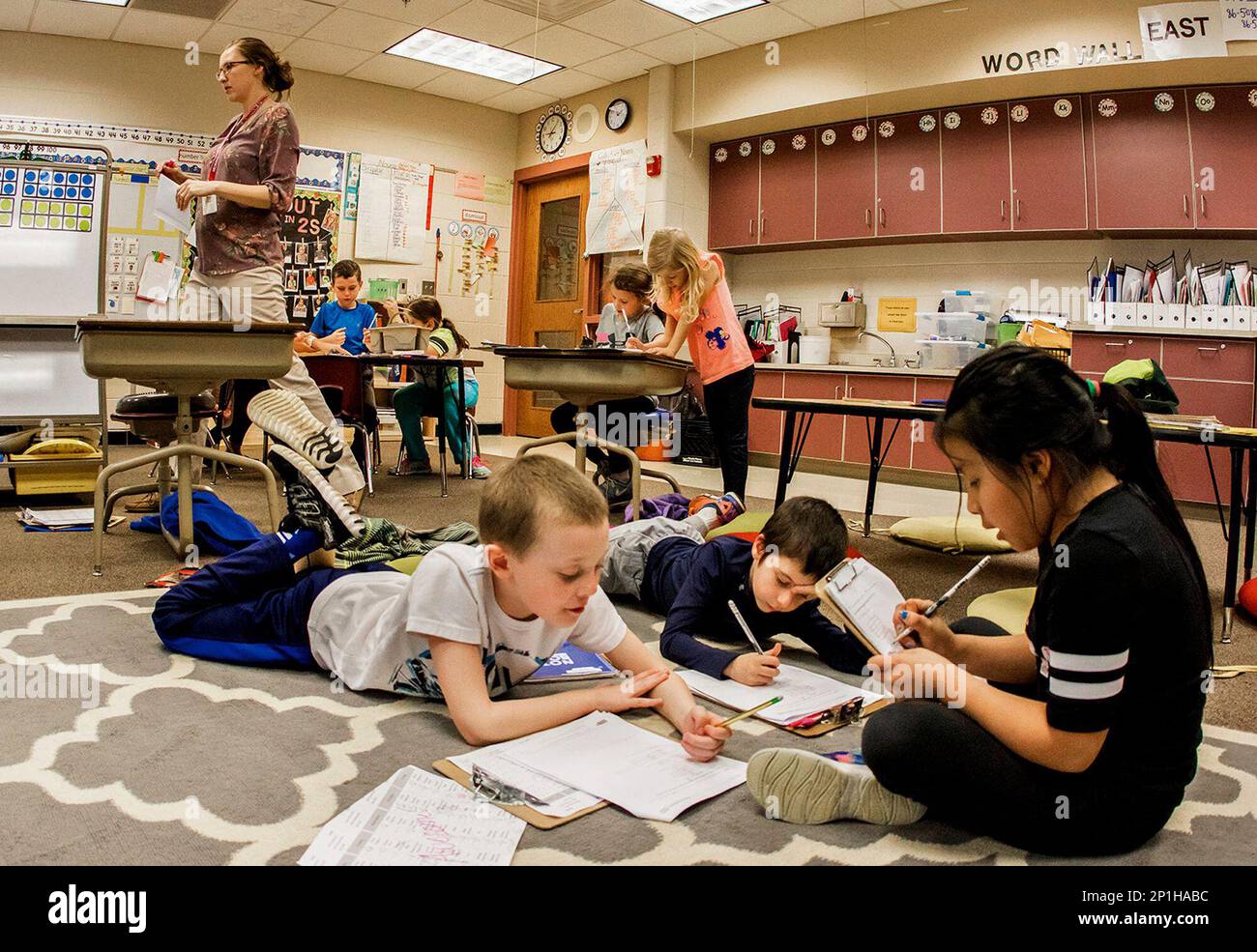 In this March 15, 2016 photo, second-graders Payton Rumfelt, 8, and ...
