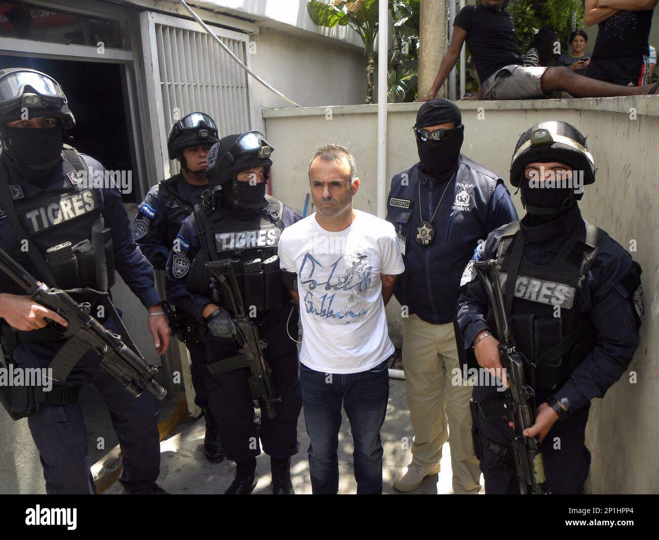 In this image released by the Honduras National Police, officers guard Franco Daniel Lombardi ...