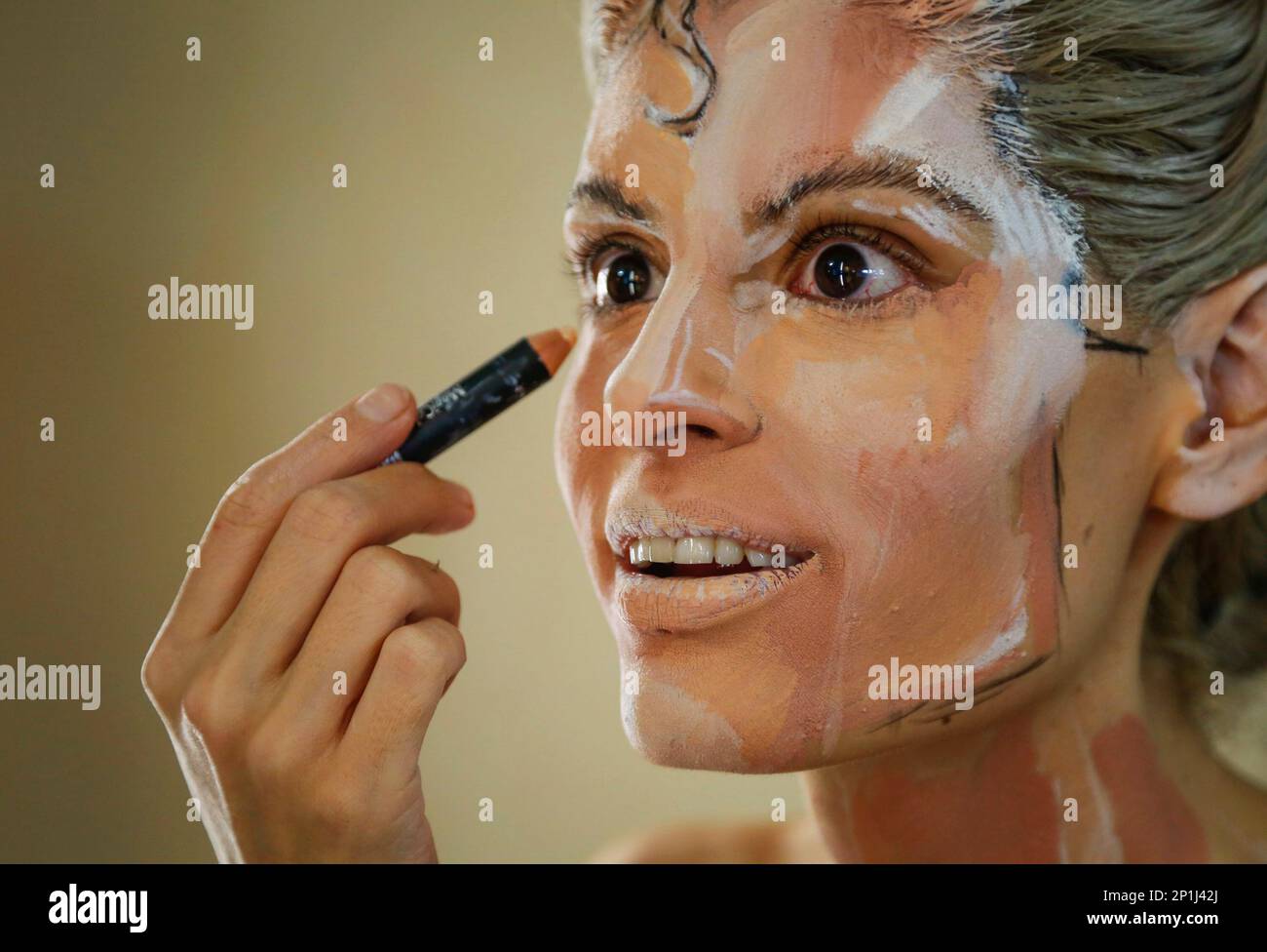 In this March 19, 2016 photo, Kay Pike transforms herself using body ...