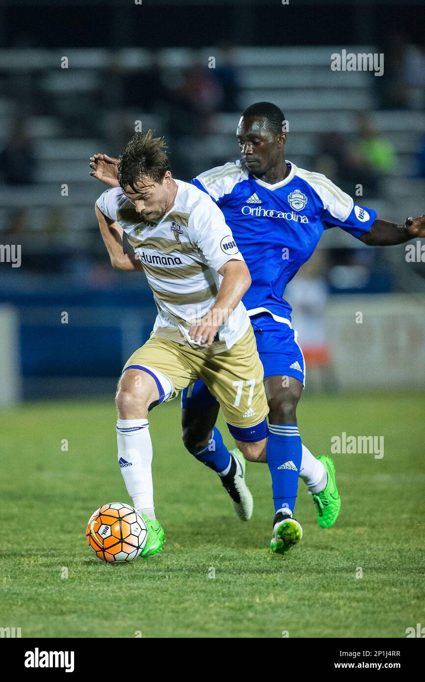 Andrew Lubahn (77) of the Louisville City FC keeps the ball away from ...