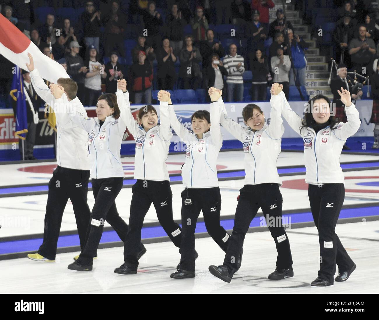 Japanese skip Satsuki Fujisawa (R) and her teammates attend the award ...