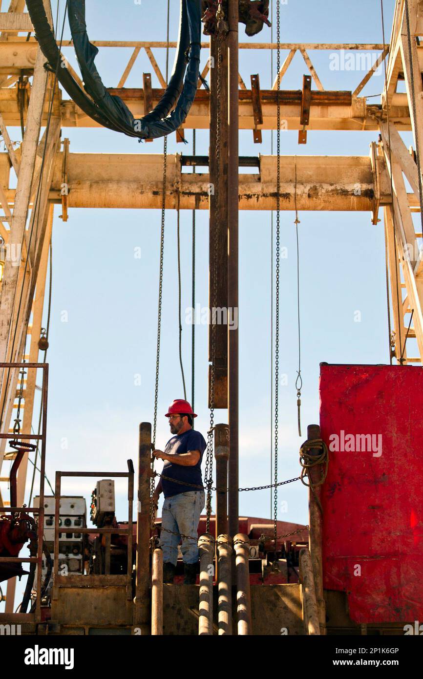 Jerry Moore, driller onboard Robinson Drilling rig #4, stands on the ...