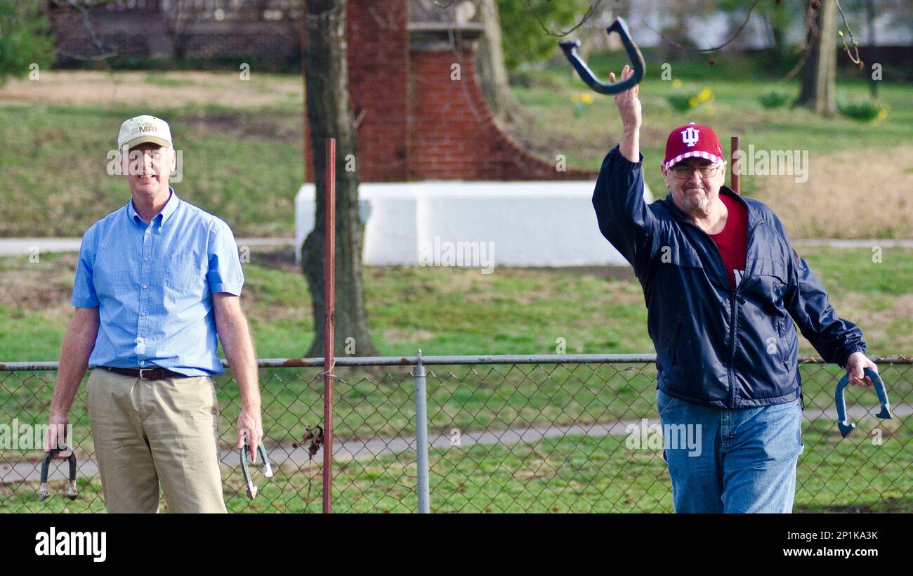 Neil Sweigart, looks on as Duane Coan pitches his horseshoe in the ...