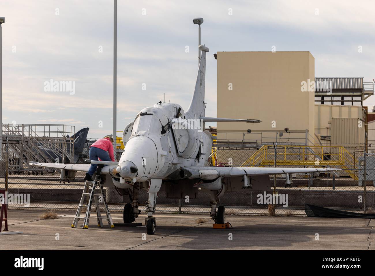 A Fleet Readiness Center East (FRCE) employee removes ratchet straps ...