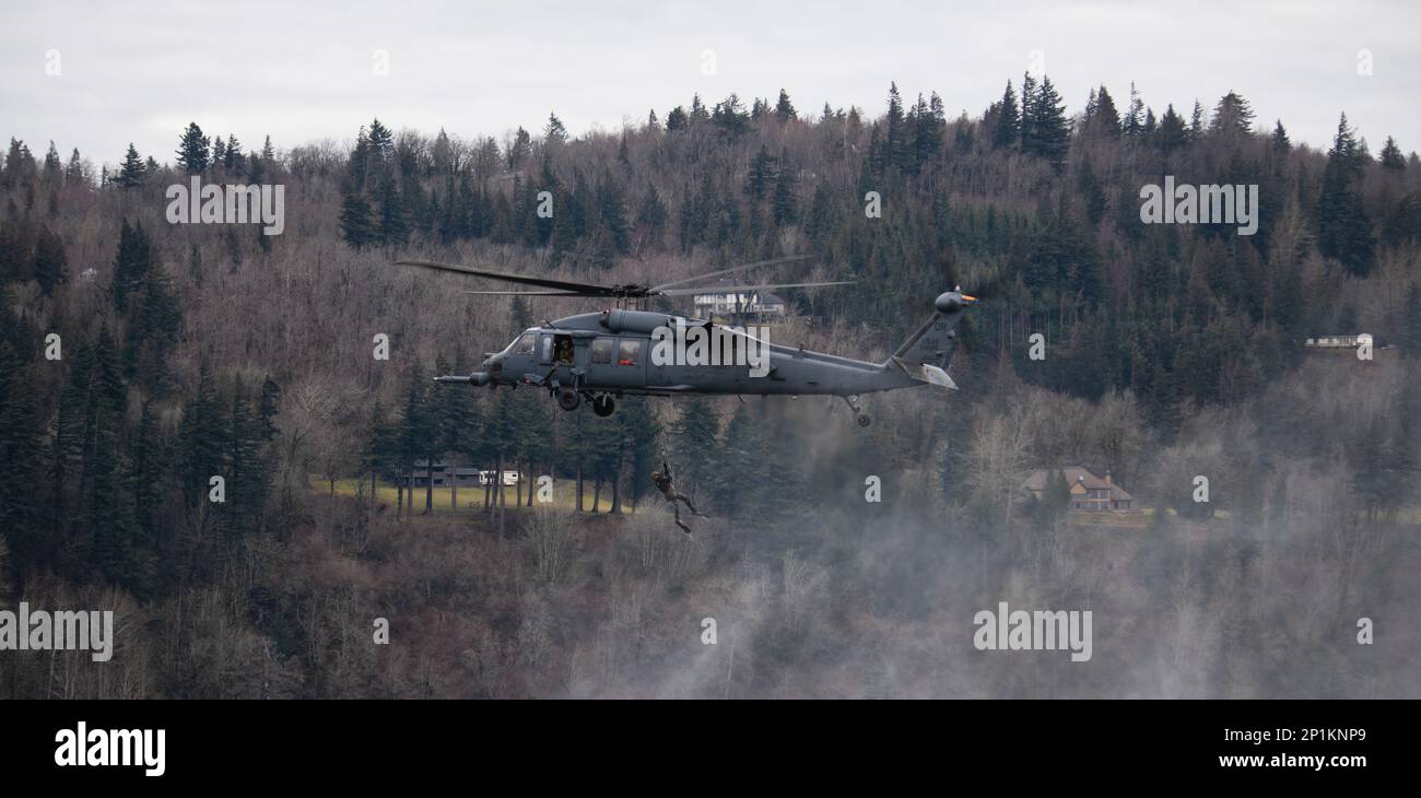 A 305th Rescue Squadron HH HH-60G Pave Hawk helicopter hovers over the ...