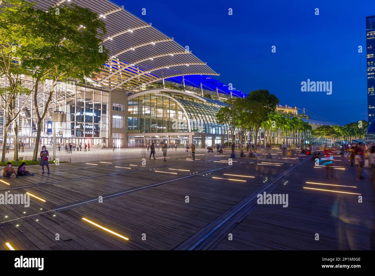 A night-time view of the waterfront promenade on Marina Bay in ...