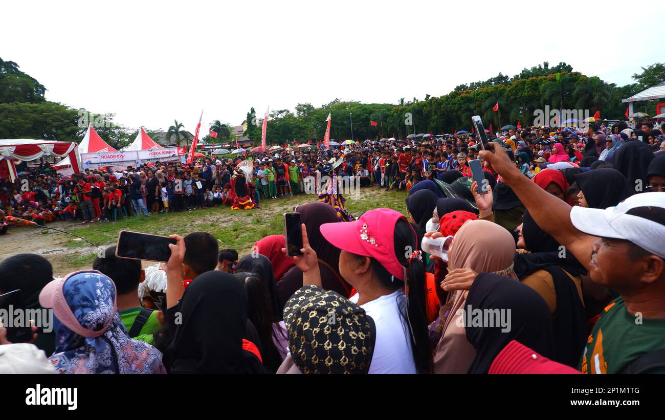 Bustling People Watching Traditional Reog Entertainment On The Gelora ...