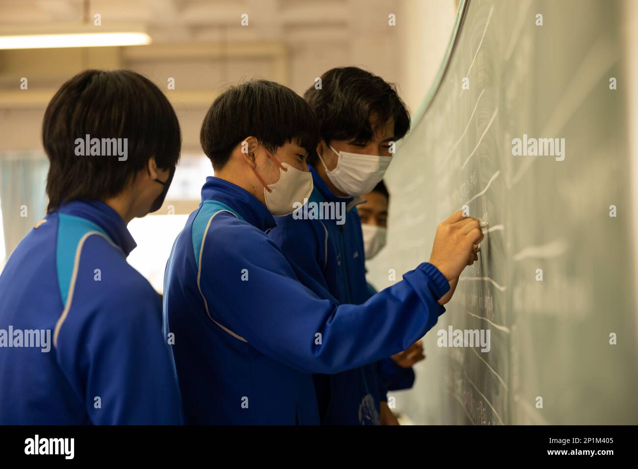 Japanese students attending Naha Nishi High School, write answers on a ...