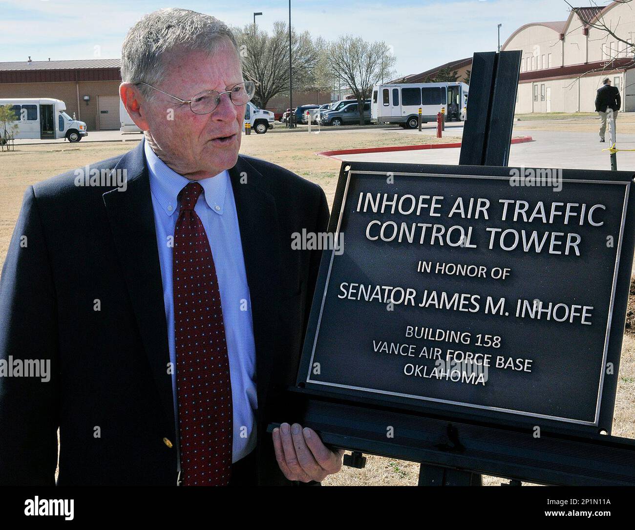 U.S. Senator James Inhofe stands next to a plaque bearing his name ...