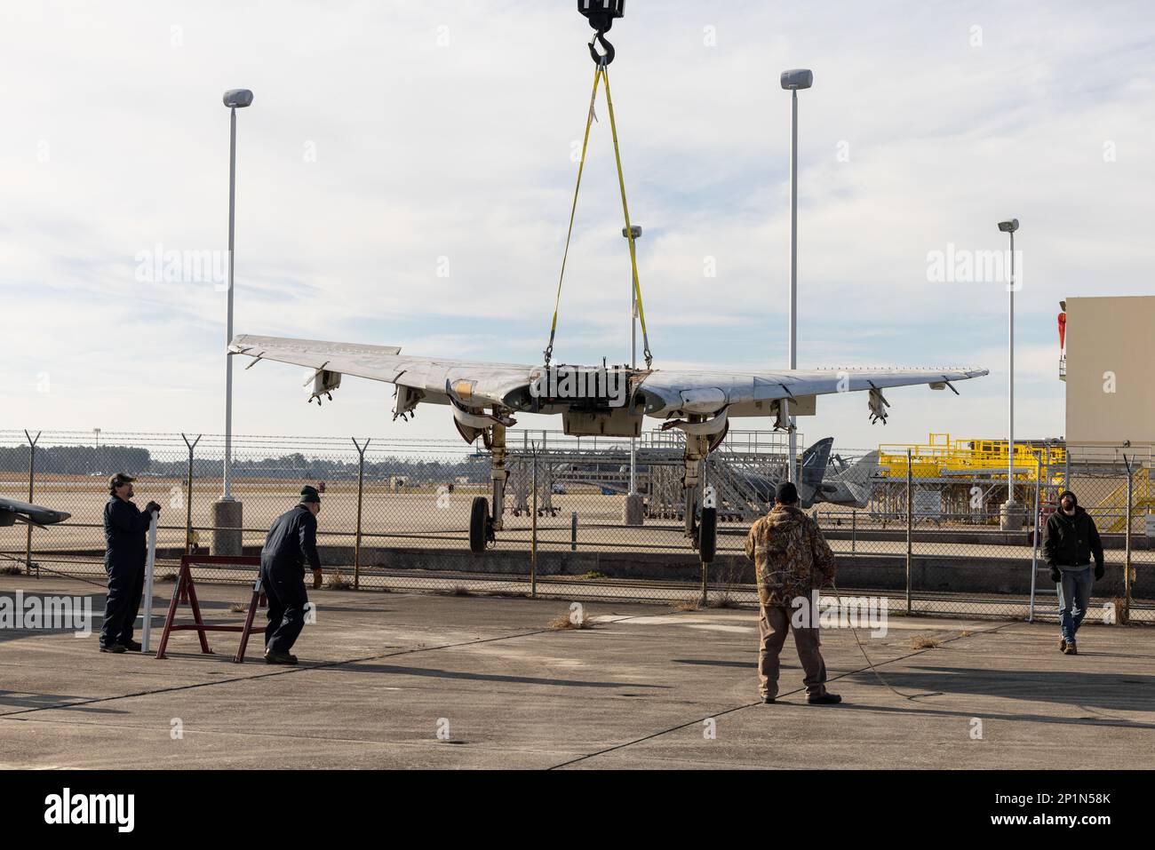Fleet Readiness Center East (FRCE) contractors lift the wings of an A ...