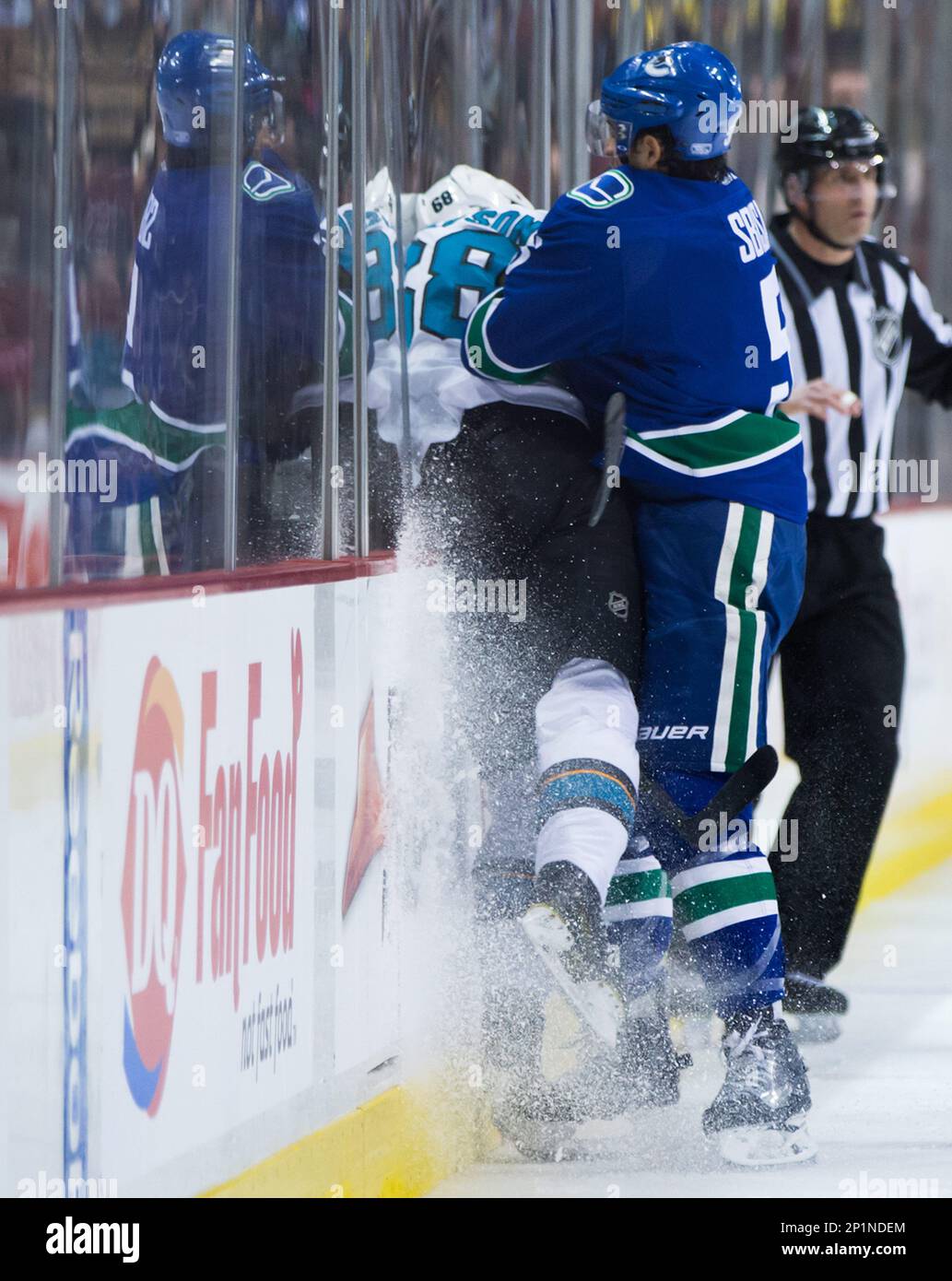 Vancouver Canucks' Luca Sbisa, right, of Italy, checks San Jose Sharks ...