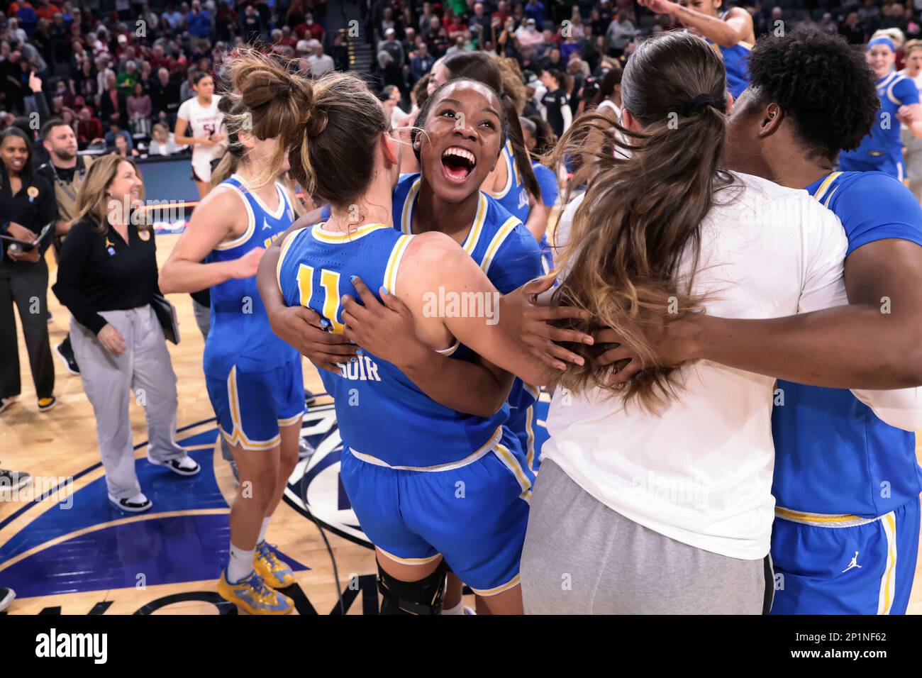 UCLA guard Charisma Osborne, center, celebrates with forward Emily ...