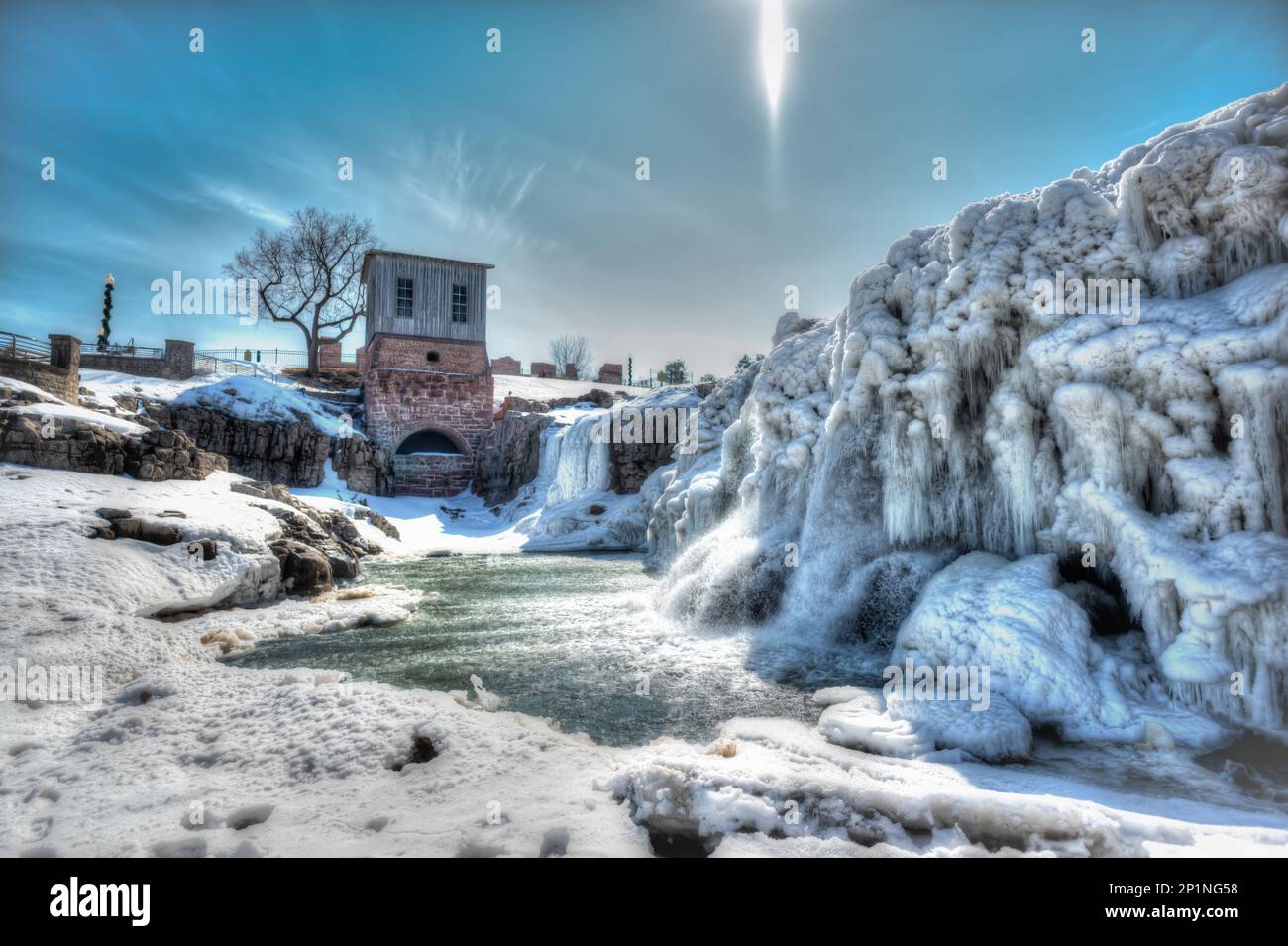 Sioux Falls Park waterfall with ice and snow. Cascading snowmelt water ...