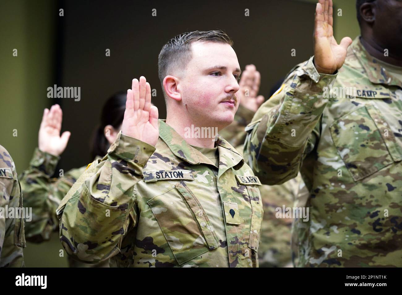 Spc. Caleb Staton reenlists during a mass reenlistment ceremony hosted ...