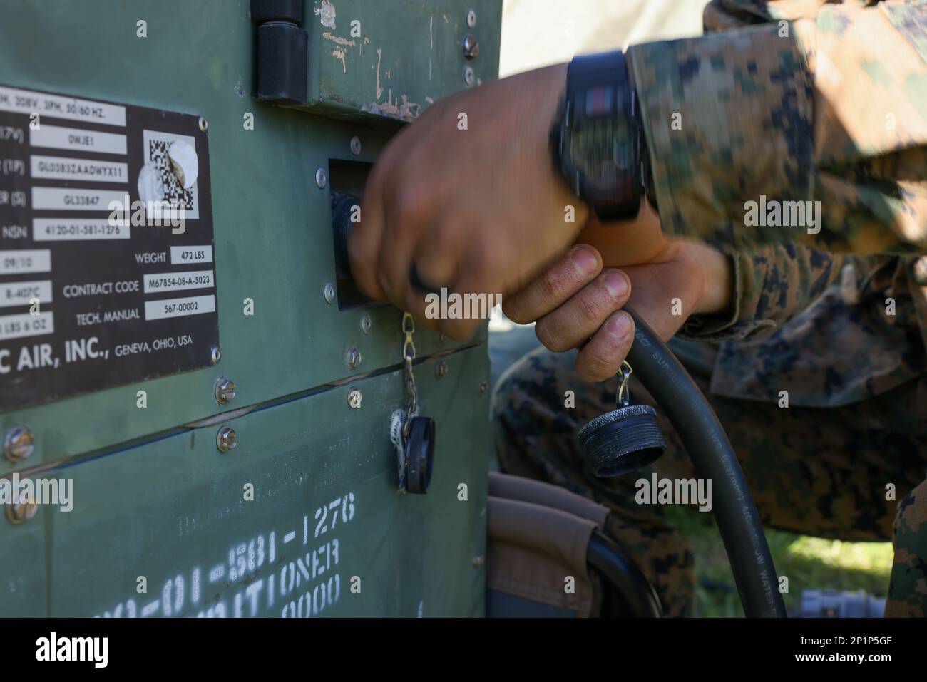 U.S. Marine Corps Lance Cpl. Joseph Miller, a refrigeration and air ...