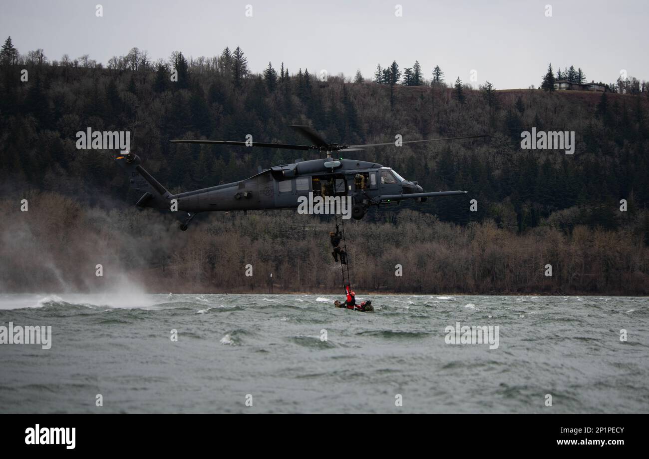 304th Rescue Squadron pararescuemen ascend a rope ladder connected to ...