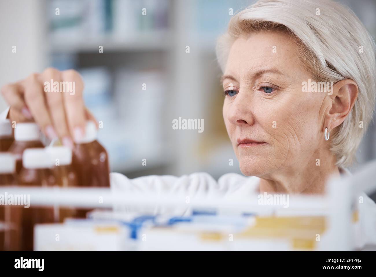 Senior woman, pharmacist and medical stock check in a pharmacy for drug ...
