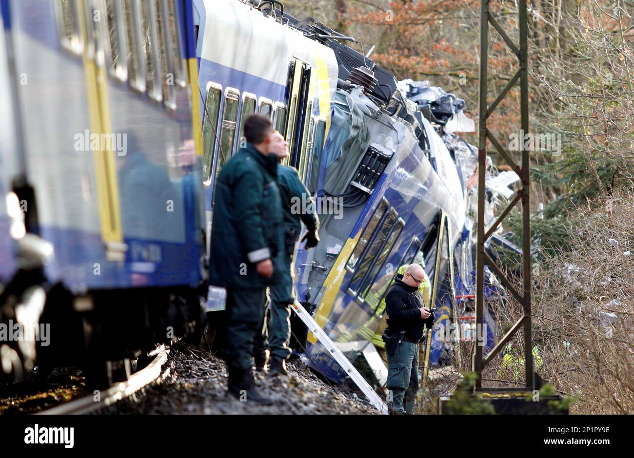 Police stand beside two trains that collided head-on near Bad Aibling ...