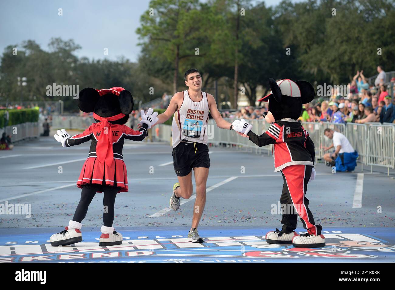 Actors dressed as Mickey Mouse, right, and Minnie Mouse, left, greet ...