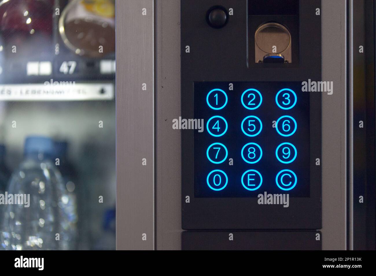 Vending machine that dispenses snacks, candies and drinks with blue ...