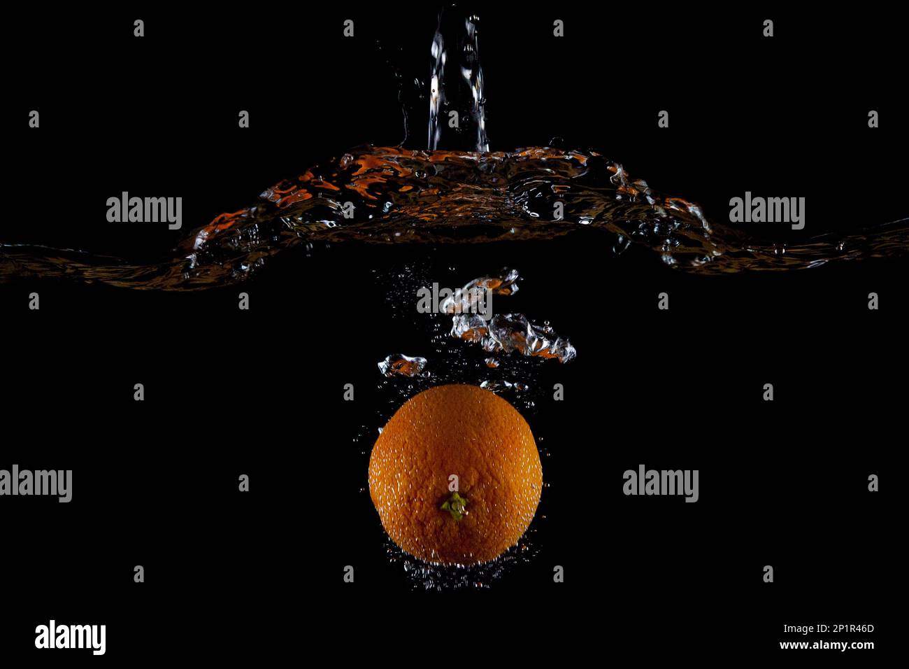 Orange water splash on black background showing water level Stock Photo ...