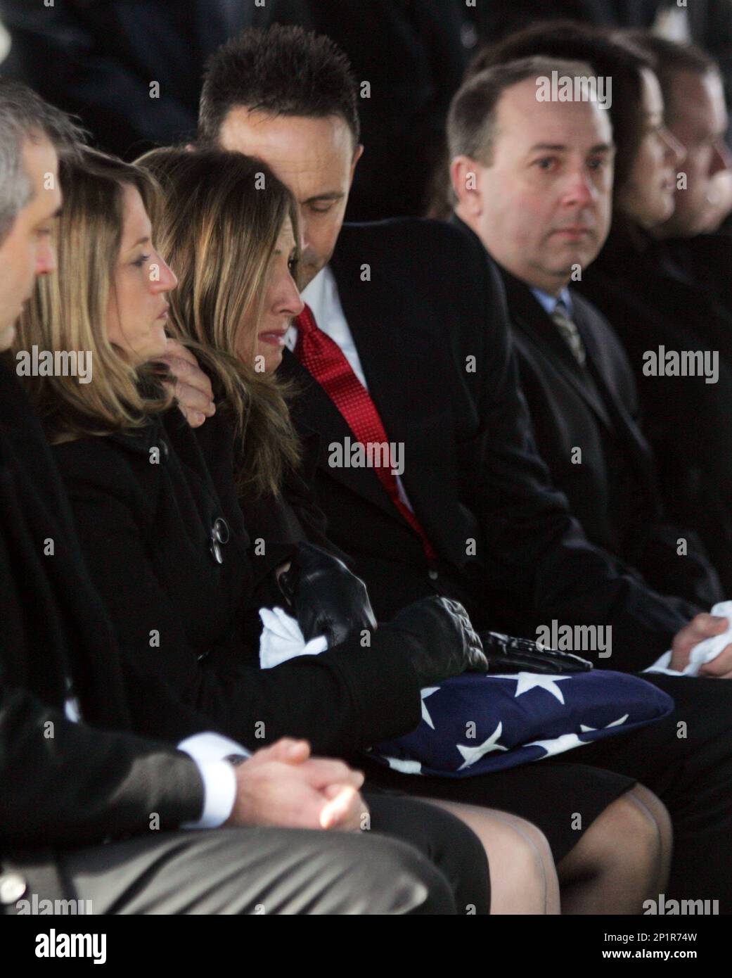 Rep.Thomas Tigue's daughter Tracy Ashby is comforted by her husband ...