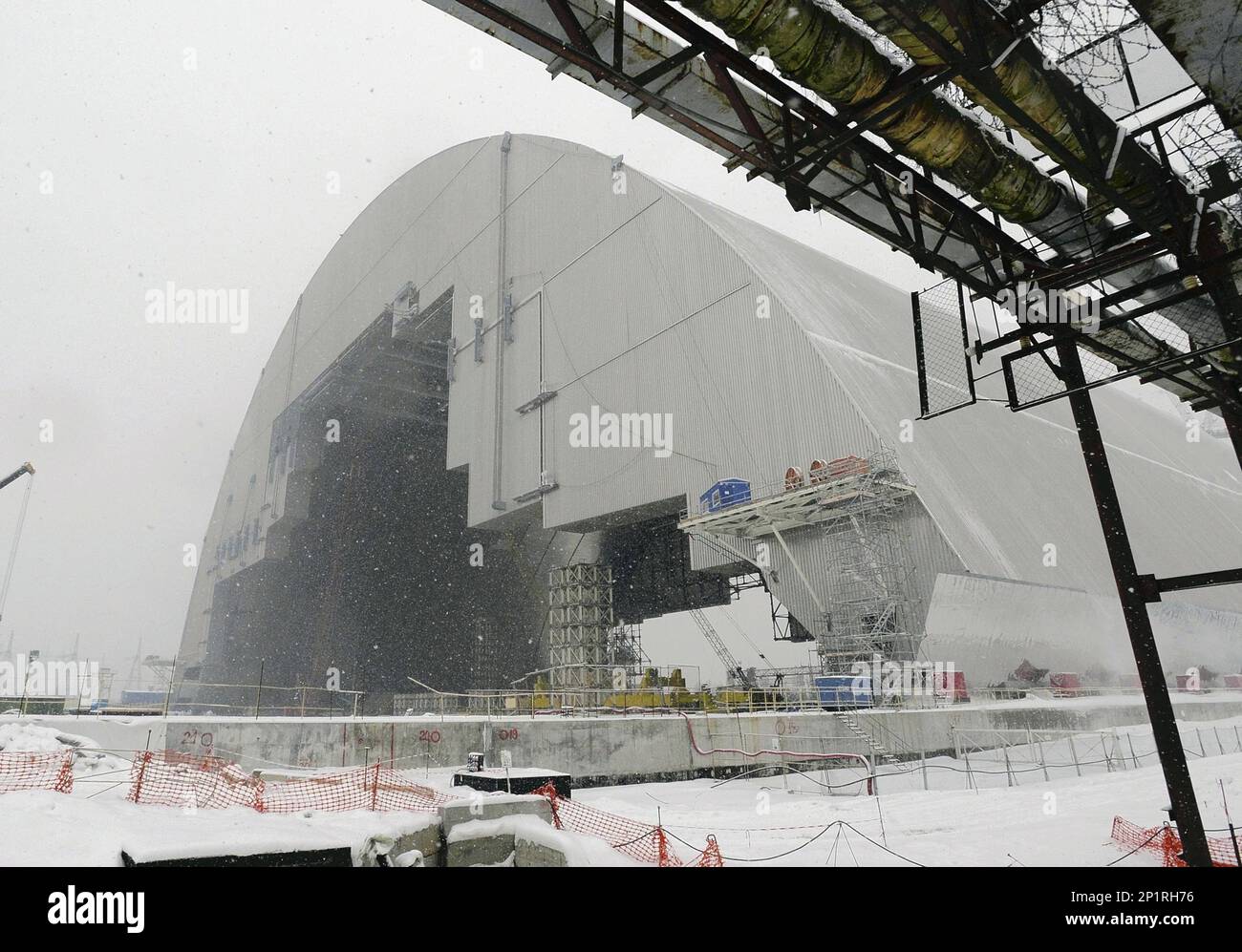 A photo shows the New Arch being constructed to encase the sarcophagus ...