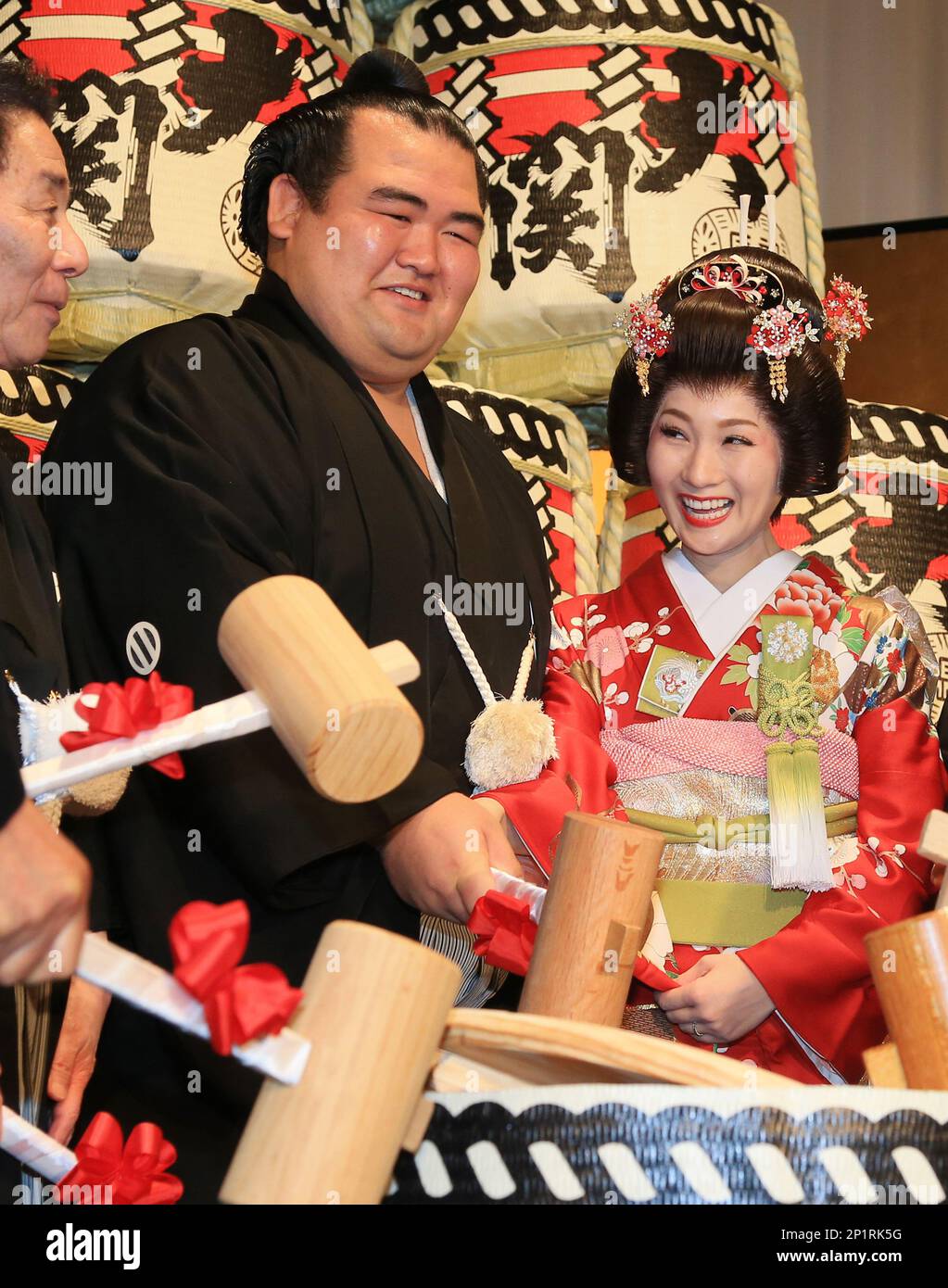 Japanese sumo wrestler ozeki Kotoshogiku (L) and his wife Yumi hold a ...