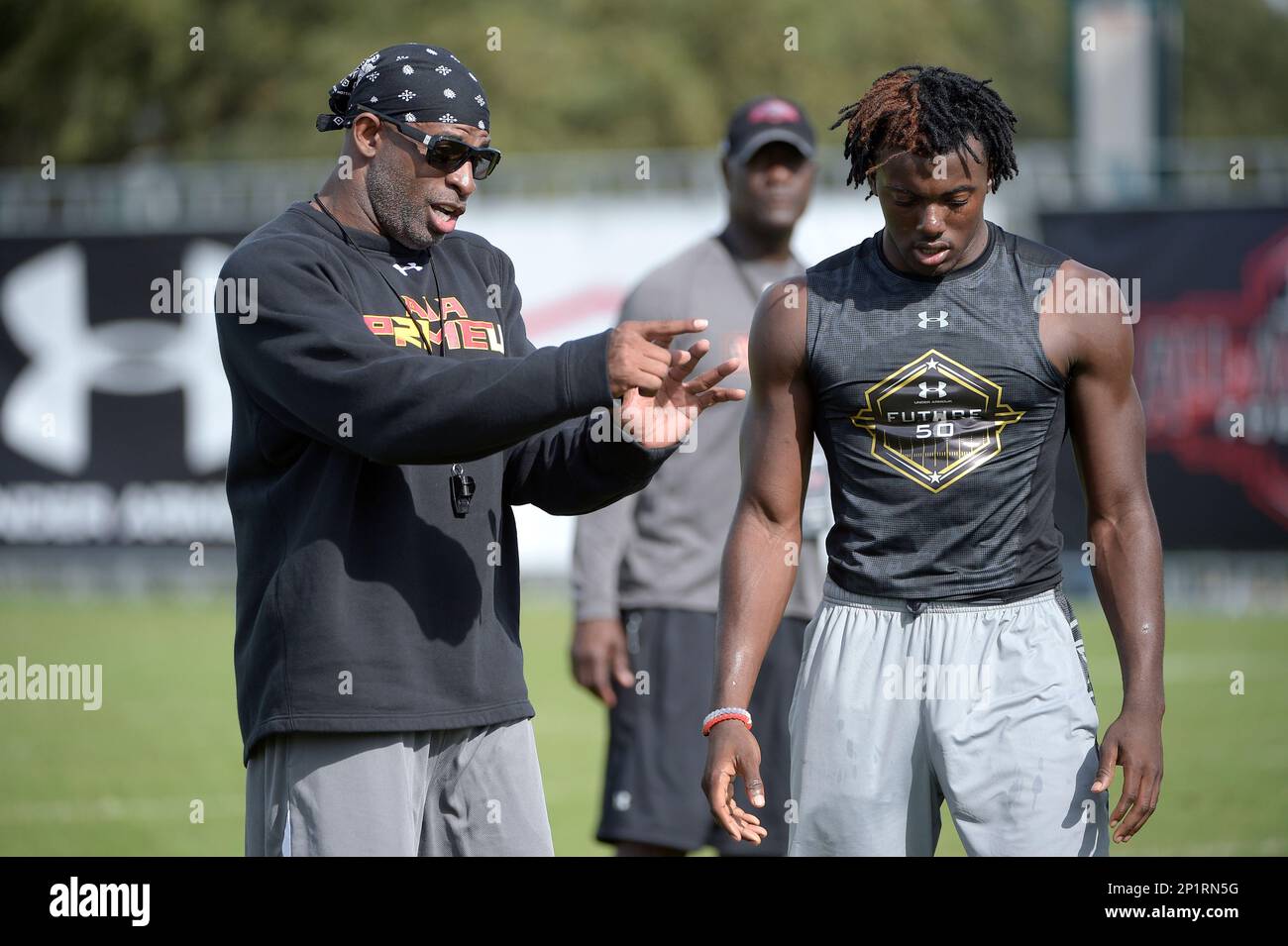 Former NFL player Deion Sanders, left, works with defensive back ...