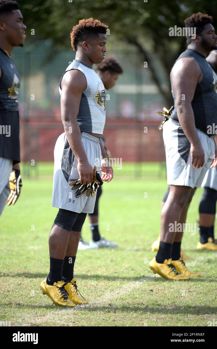 Running back Toneil Carter, center, works out during the Under Armour ...