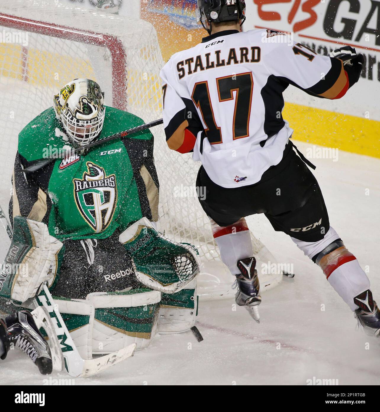 Prince Albert Raiders' goalie Rylan Parenteau, left, makes a save ...