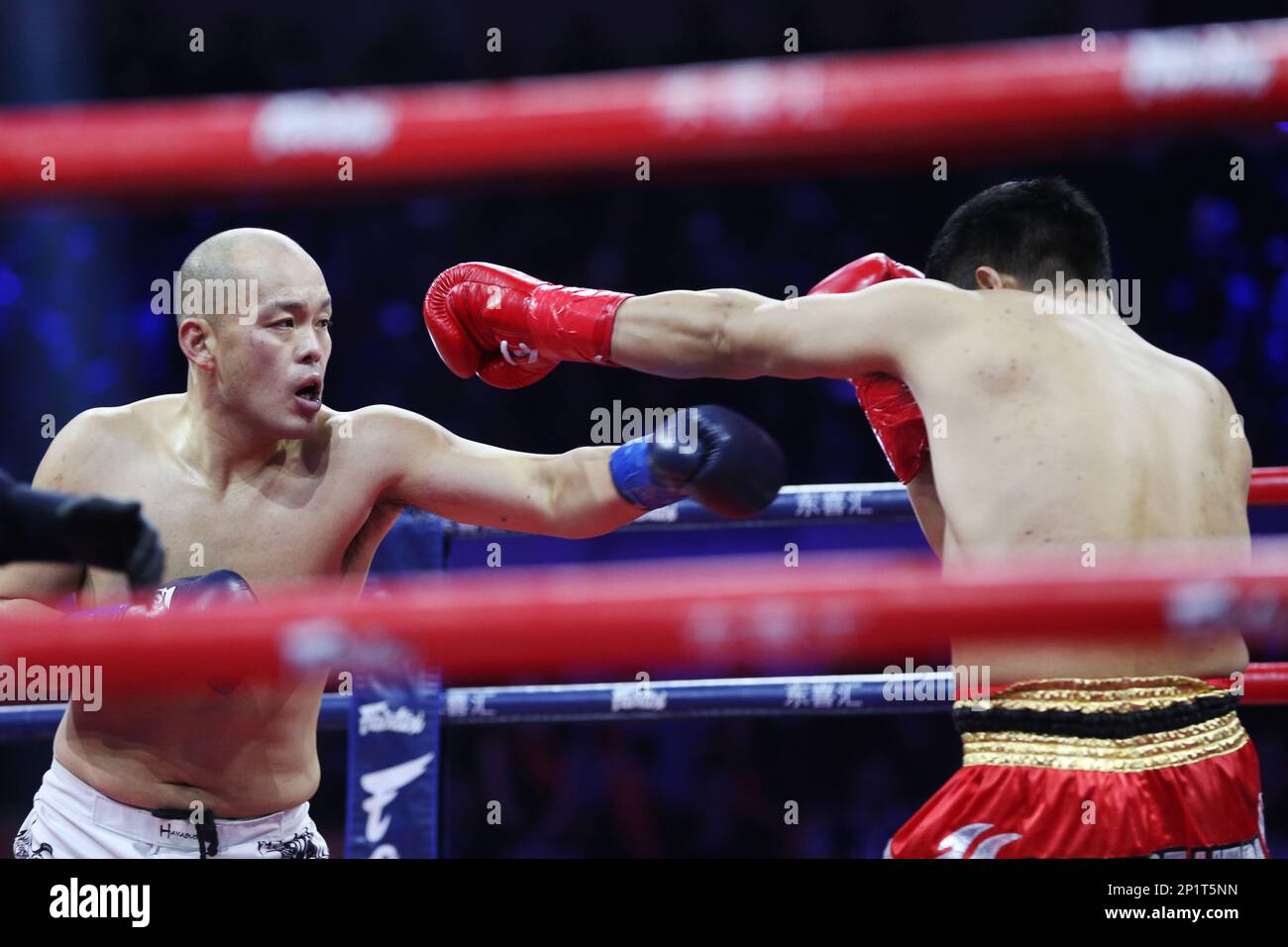 Chinese boxer Wang Hongxiang, right, fights Japanese boxer KING in ...