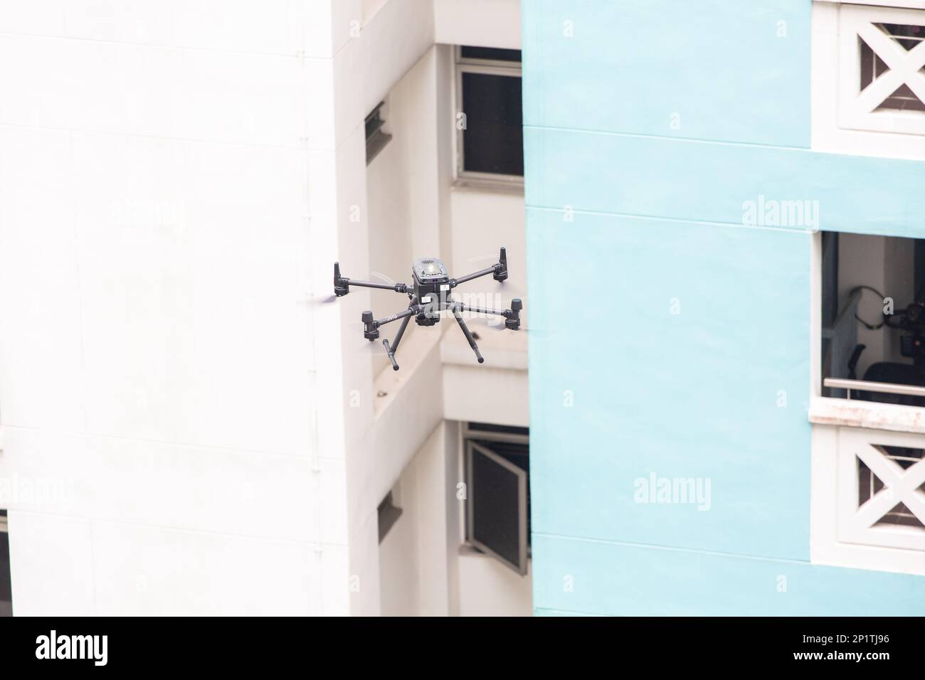 A drone in mid-air conducting maintenance service of a building ...
