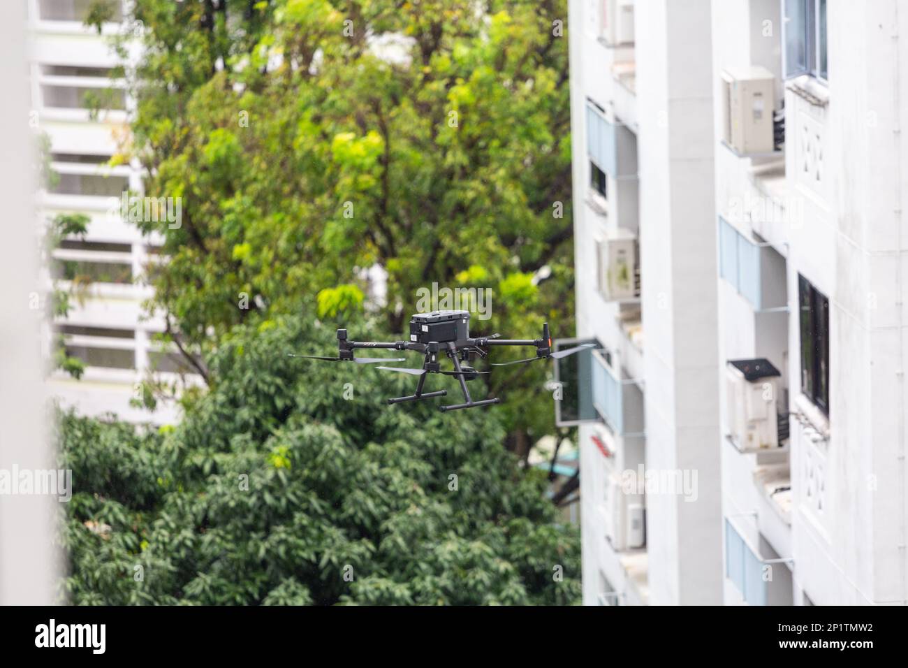 A drone in mid-air conducting a building inspection to identify any ...