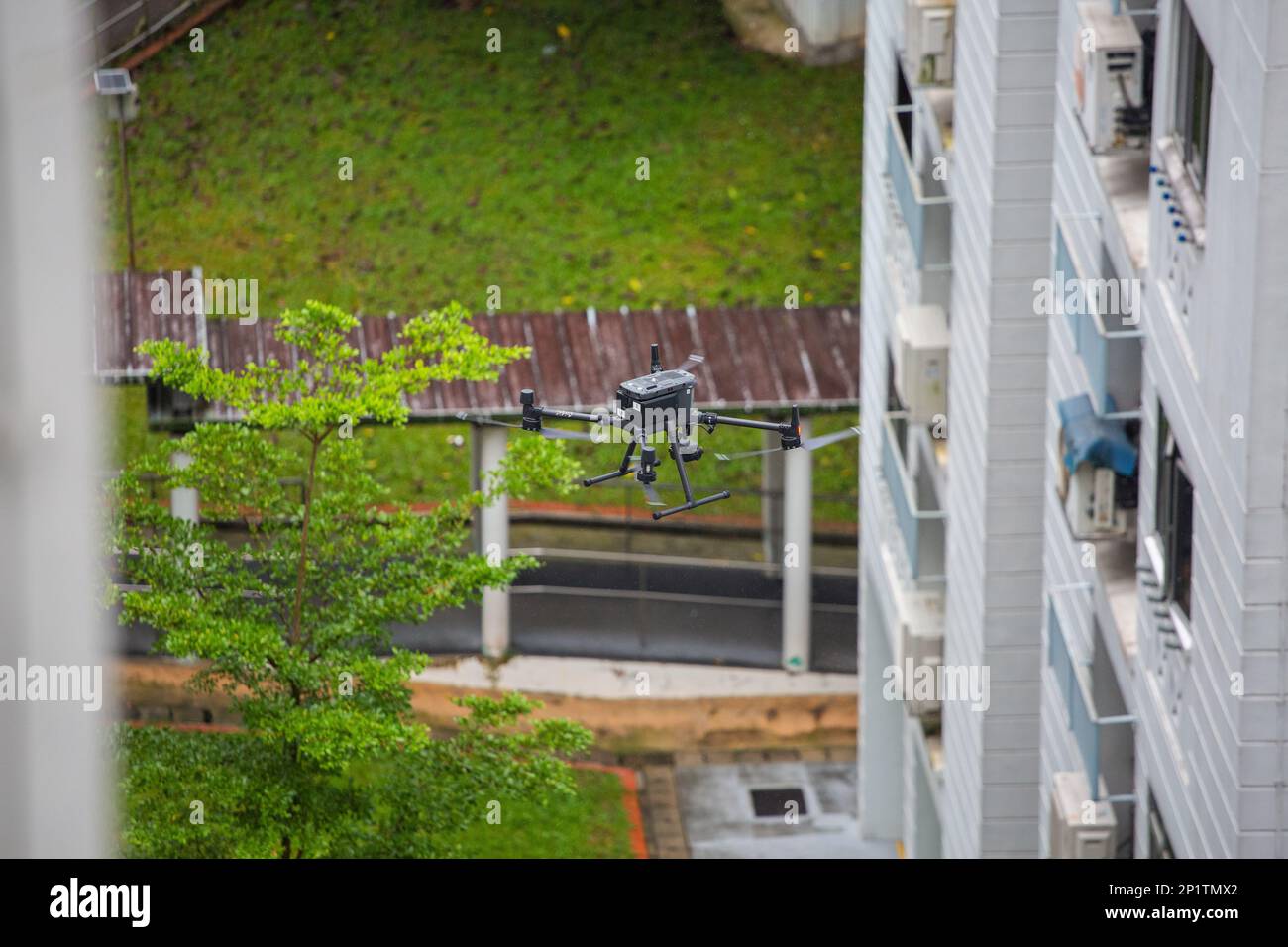 A drone in mid-air conducting a building inspection to identify any ...