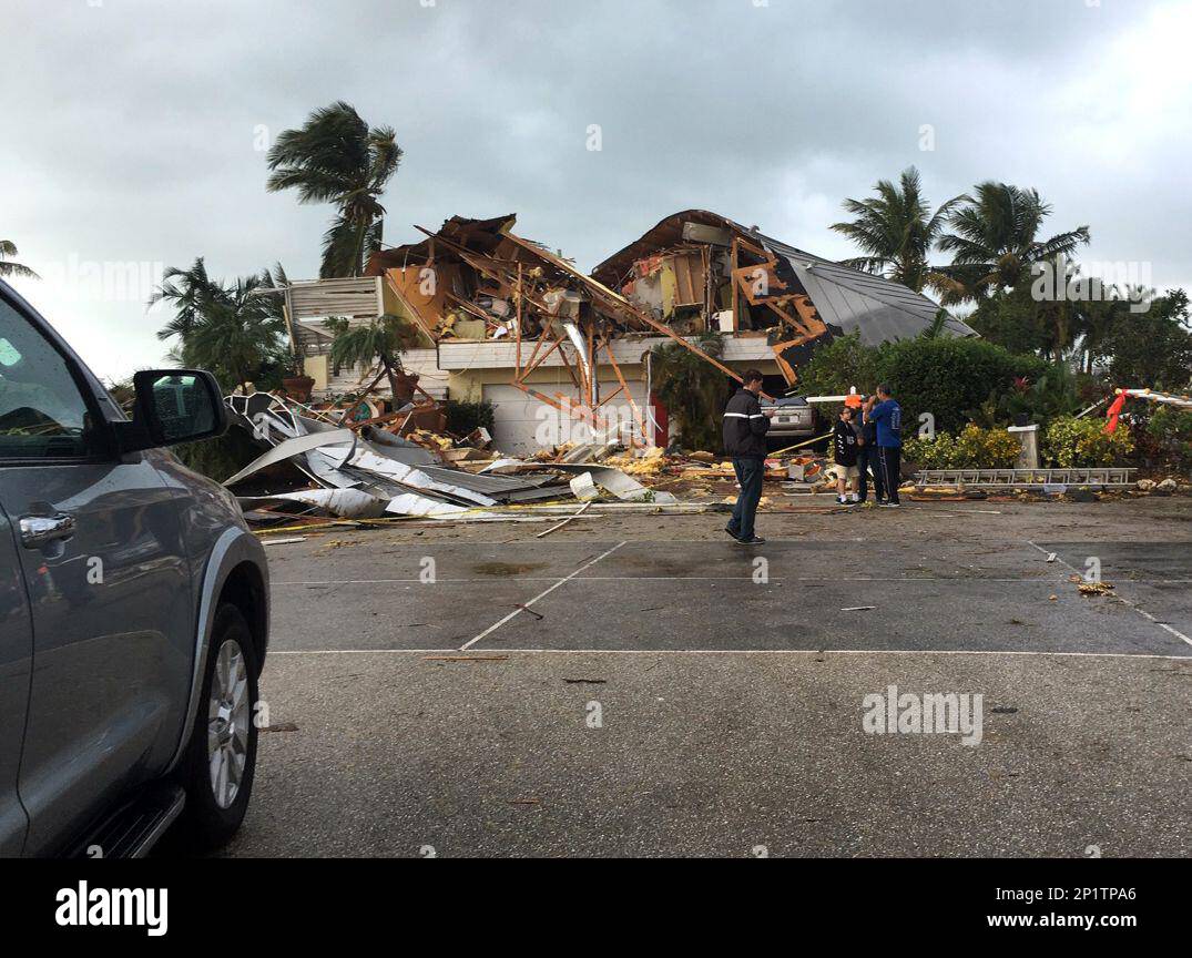 People look at debris and damage after a tornado stuck in Siesta Key ...