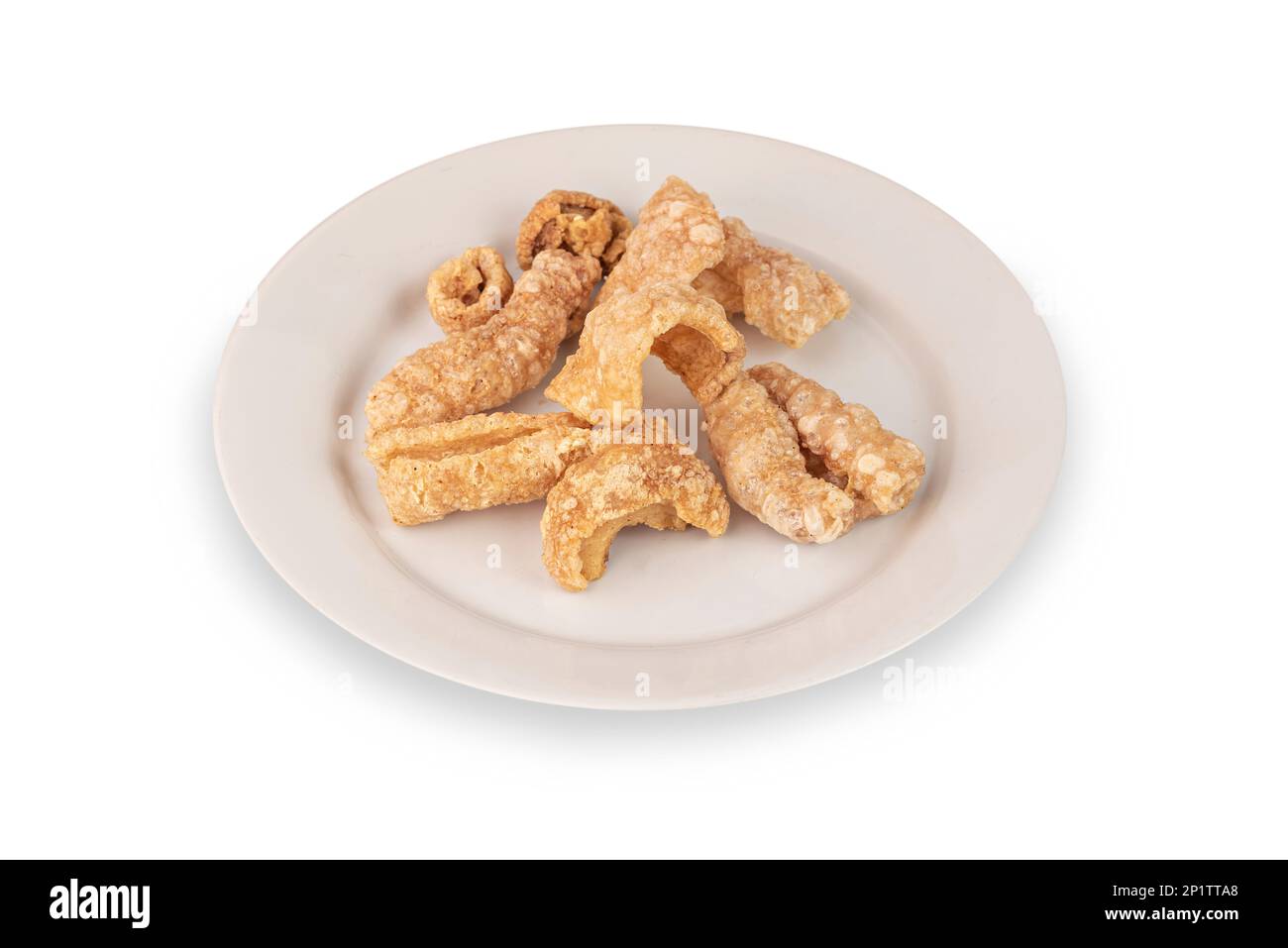 pork scratching or pork crackling on dish on dish over white background ...