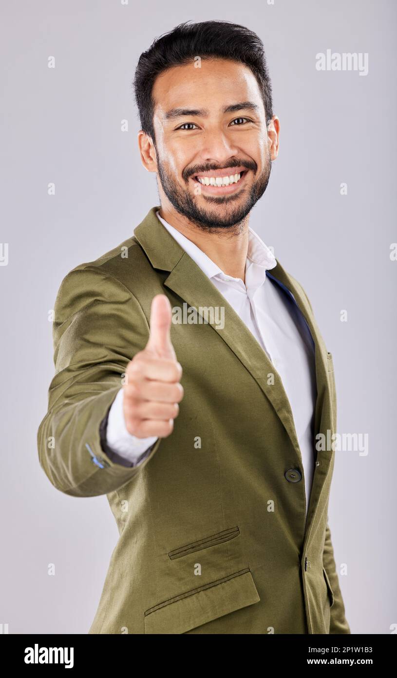 Business portrait, smile and Asian man with thumbs up in studio ...