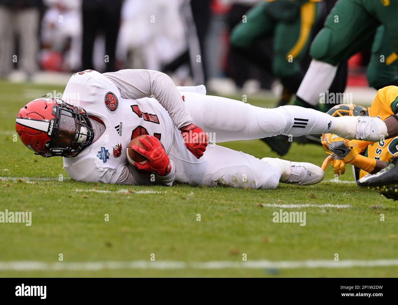 Jacksonville State's running back Miles Jones (21) is brought down by ...