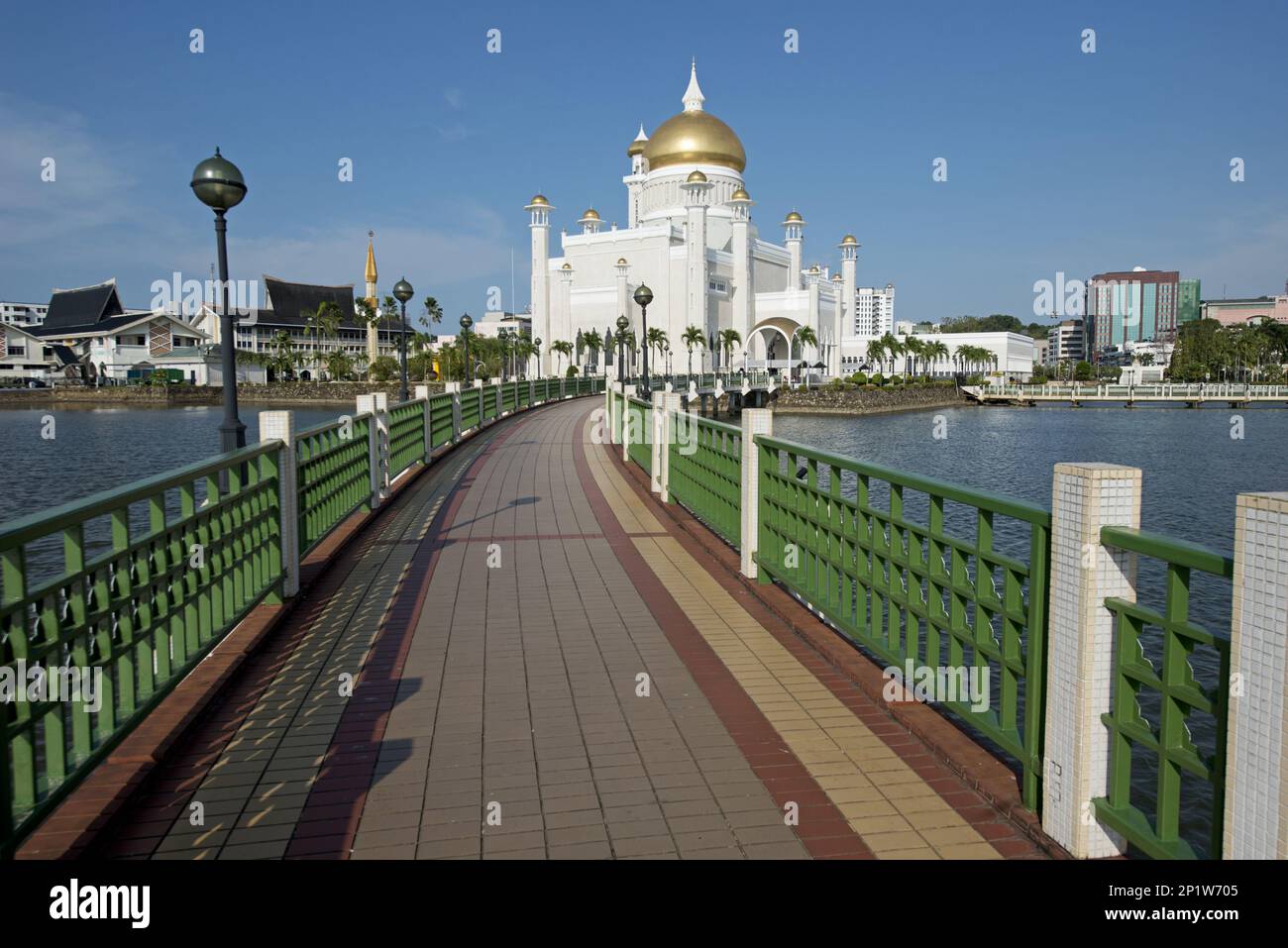 View of the walkway across the artificial lagoon to the mosque with ...