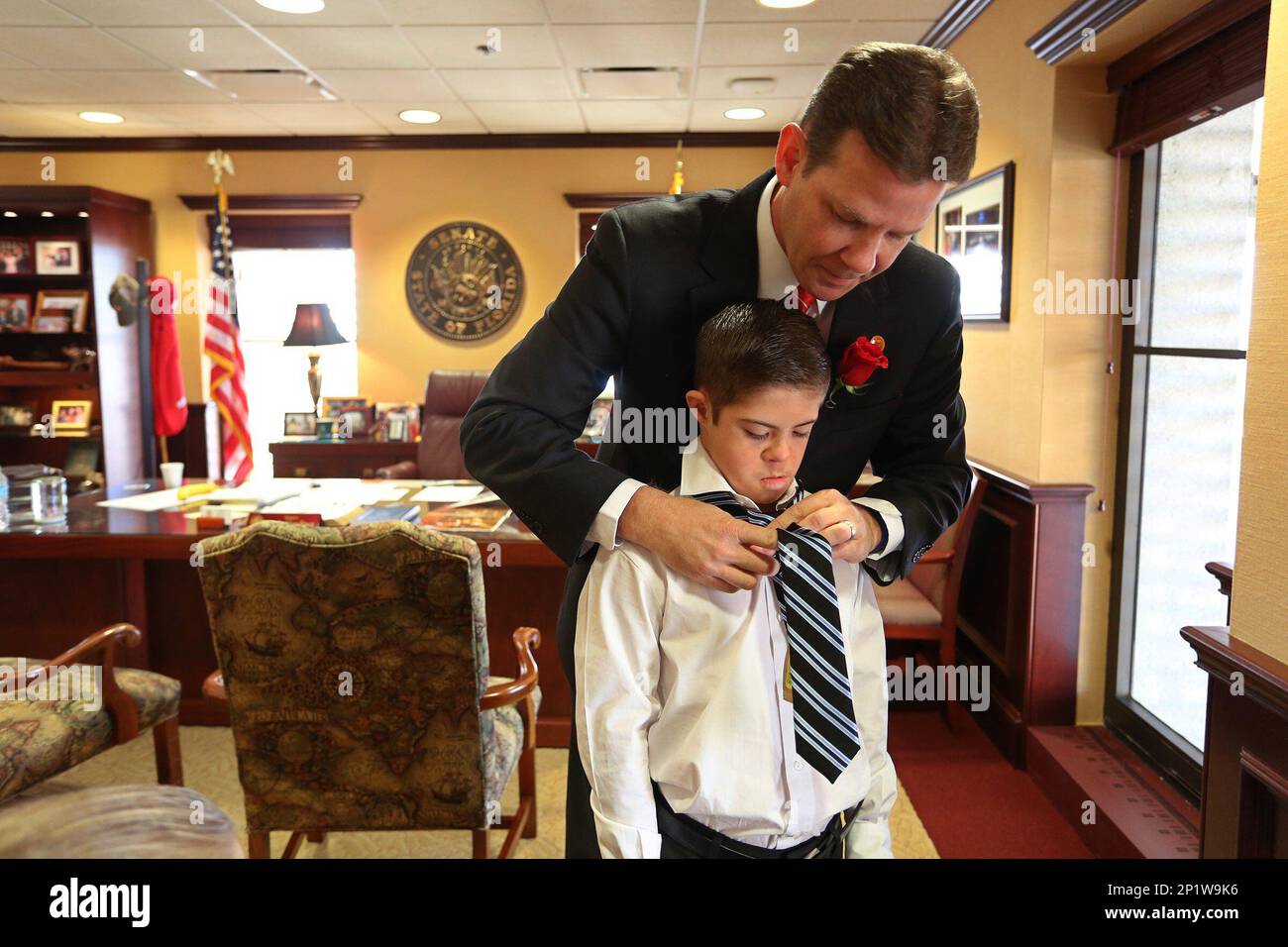 Florida Senate President Andy Gardiner, R- Orlando, helps his son ...