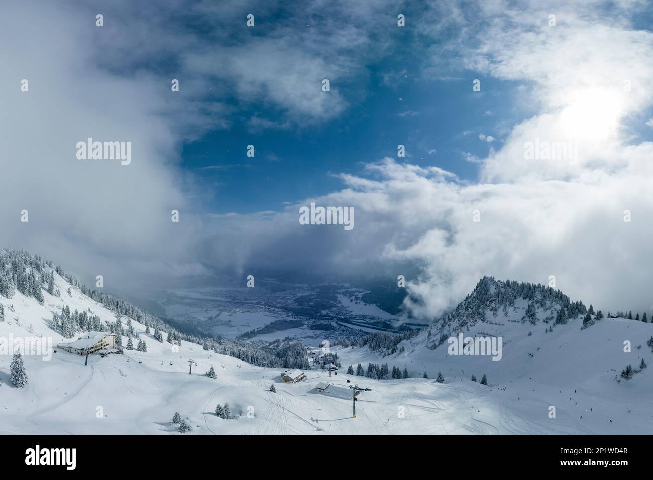 hahnenkamm ski area in tyrol with a view of the deep wintry town of ...